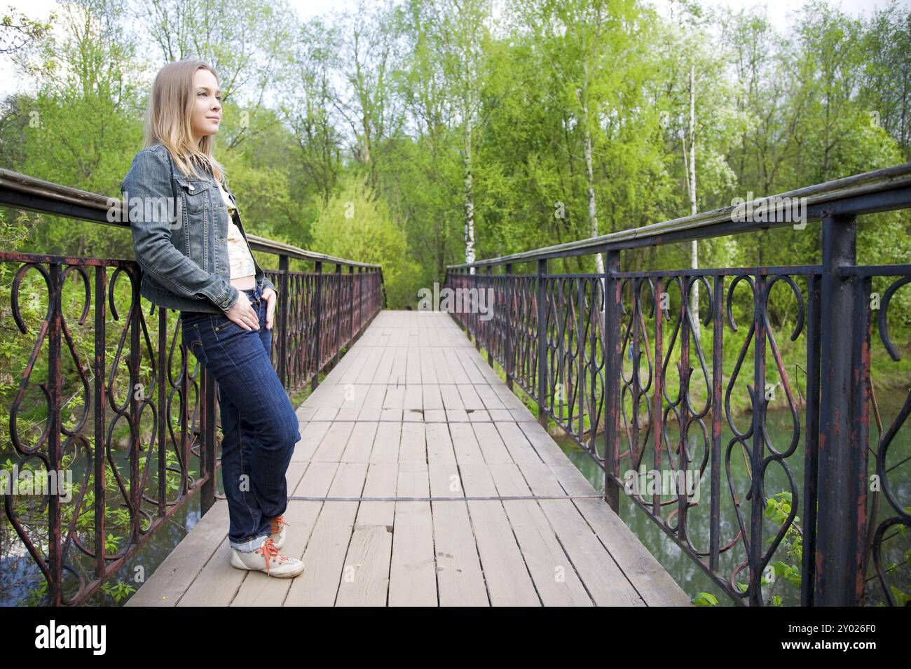 Young Woman Looking Forward From The Bridge Stock Photo - Alamy