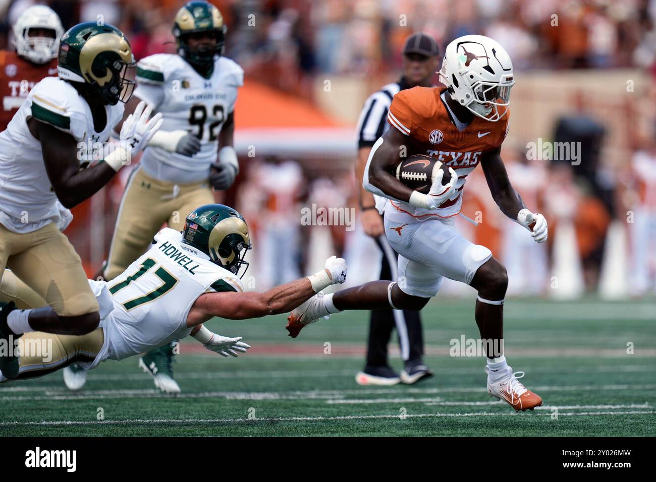 Texas running back Quintrevion Wisner, right, escapes the grasp of ...