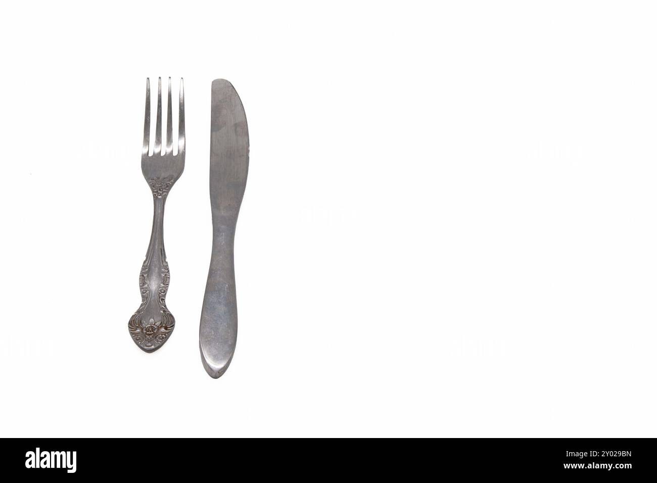 Metal fork and table knife on white isolated background. Horizontal ...