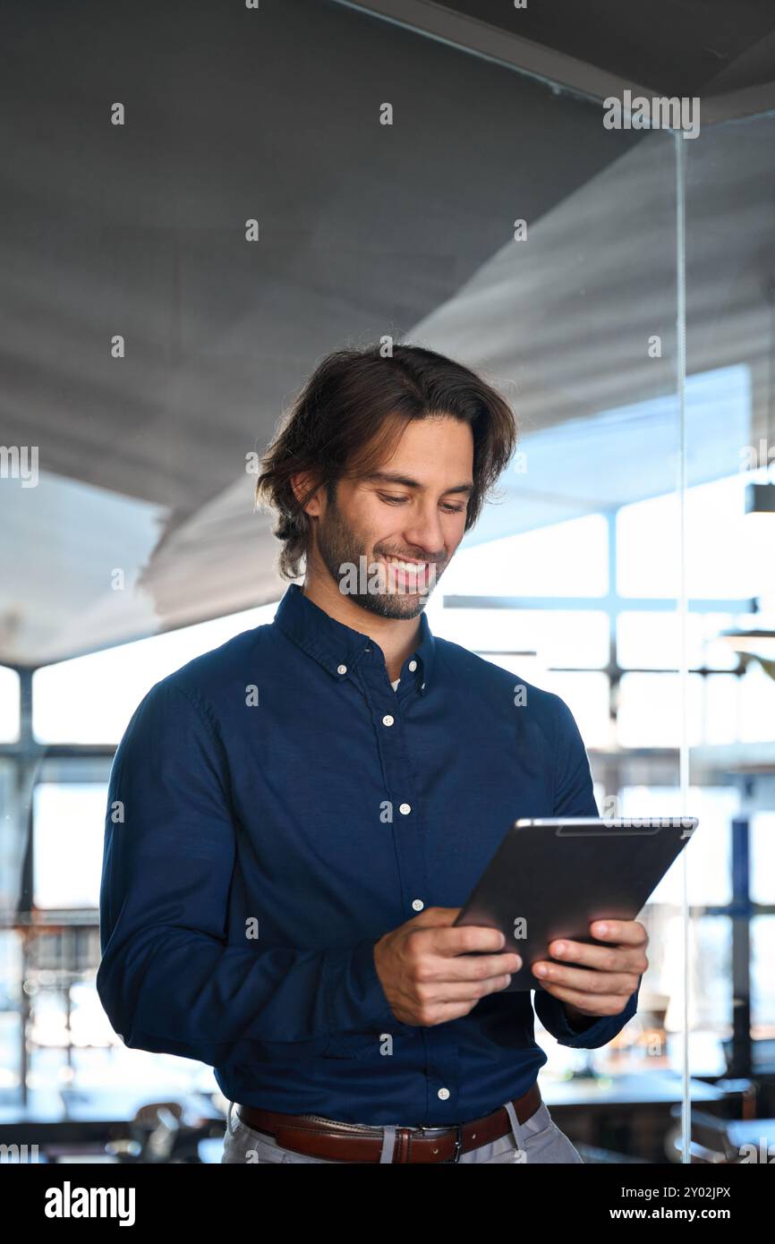 Vertical photo of business man executive using digital tab standing in ...