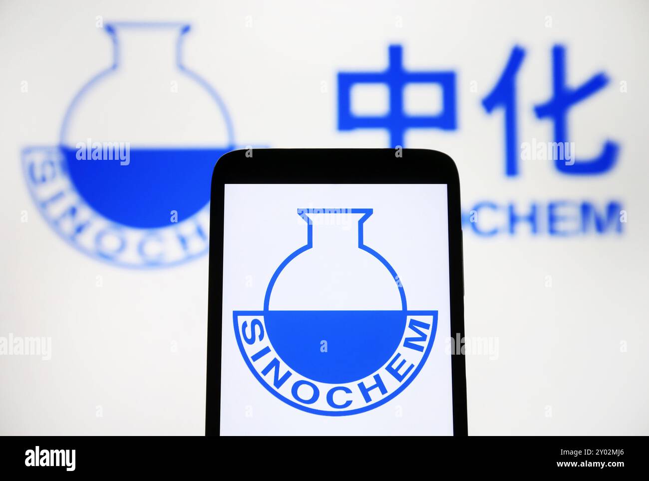 In this photo illustration, a Sinochem logo is seen on a smartphone and ...
