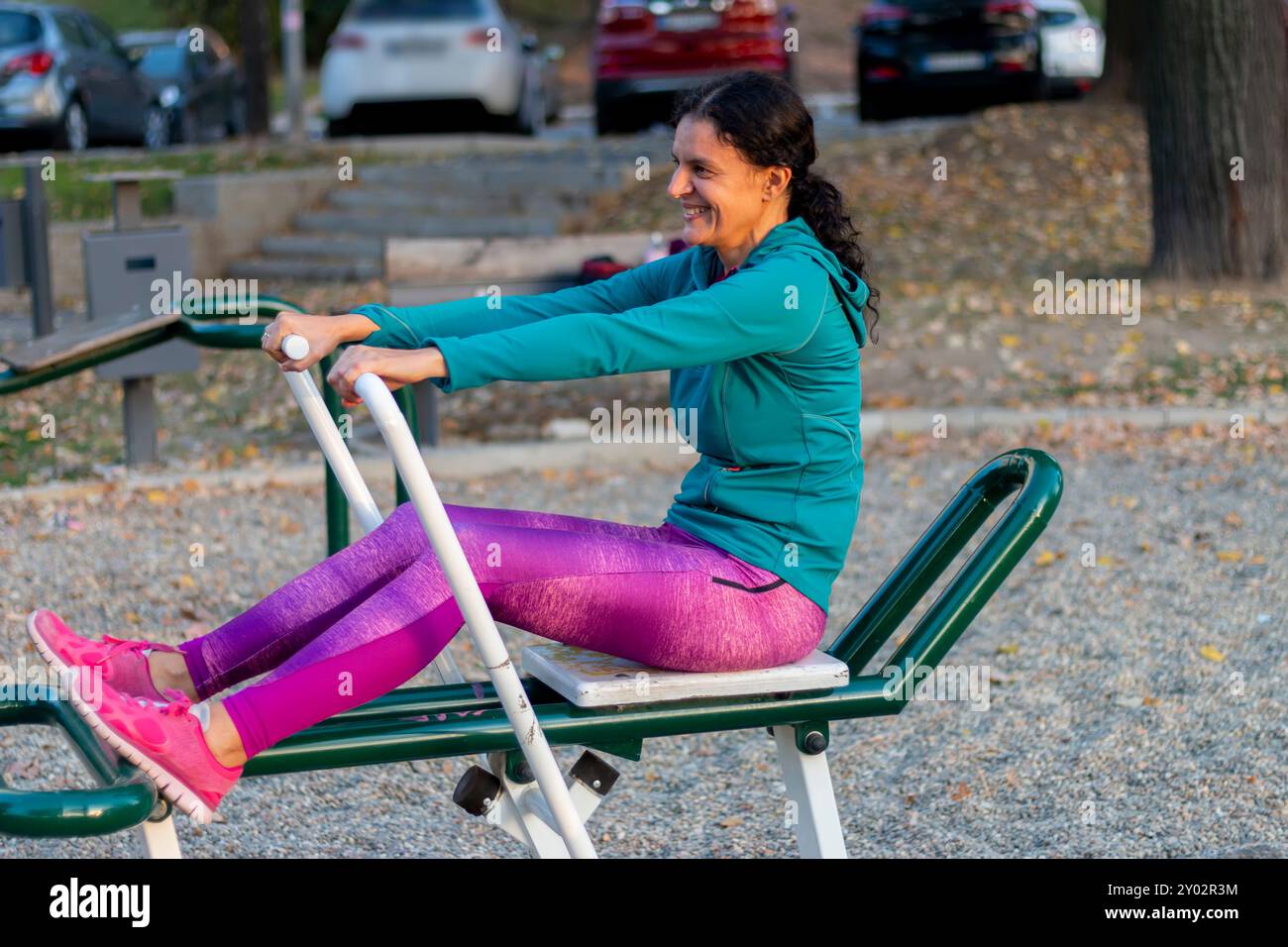Attractive middle-aged woman working out in the gym and leading a ...