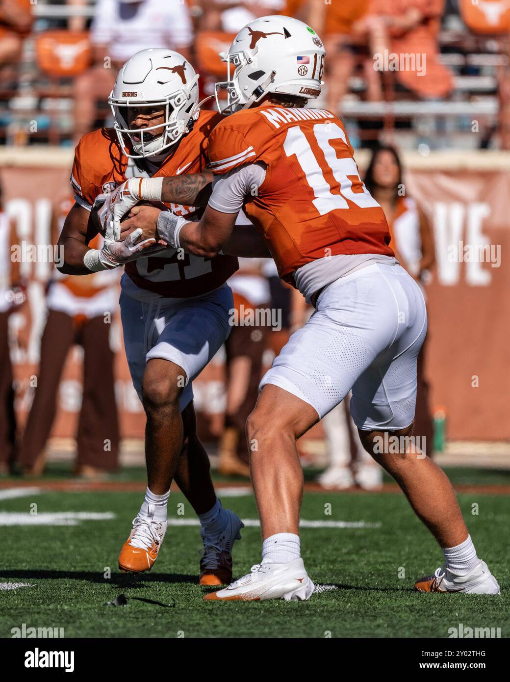 Aug 31, 2024.Arch Manning #16 hands the ball to Ryan Niblett #21 of the ...