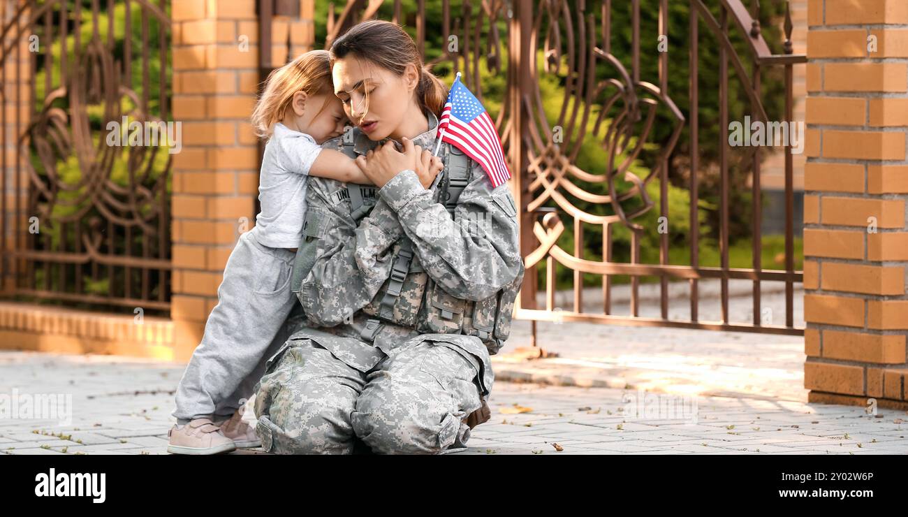 Female soldier hugging her little daughter outdoors Stock Photo - Alamy