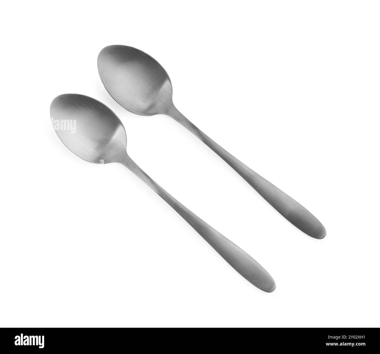 Stainless steel spoons on white background Stock Photo - Alamy