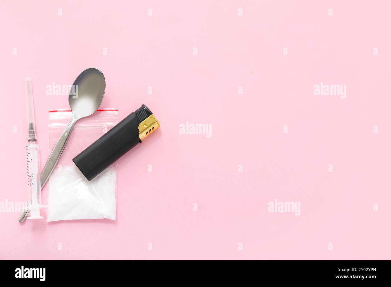 Drugs, spoon, lighter and syringe on pink background Stock Photo - Alamy