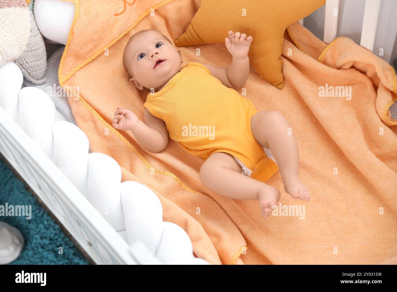Cute baby lying in crib, top view Stock Photo - Alamy
