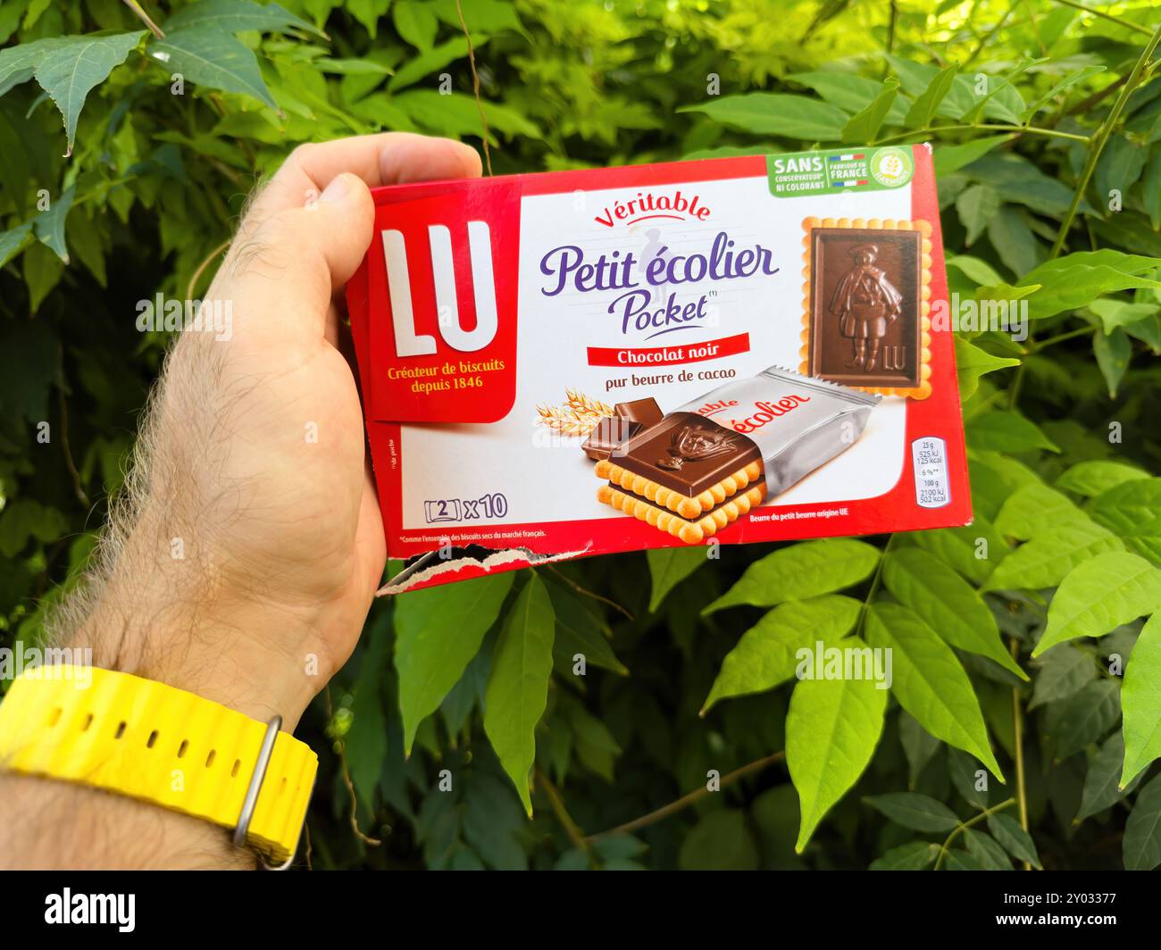Frankfurt, Germany - Aug 20, 2024: POV of a male hand holding a package ...