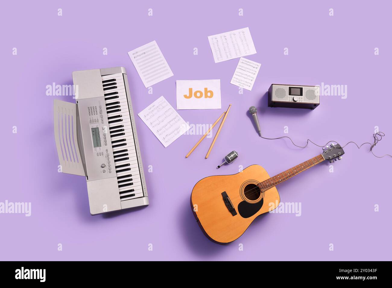 Paper with word JOB, note sheets and musical instruments on lilac ...