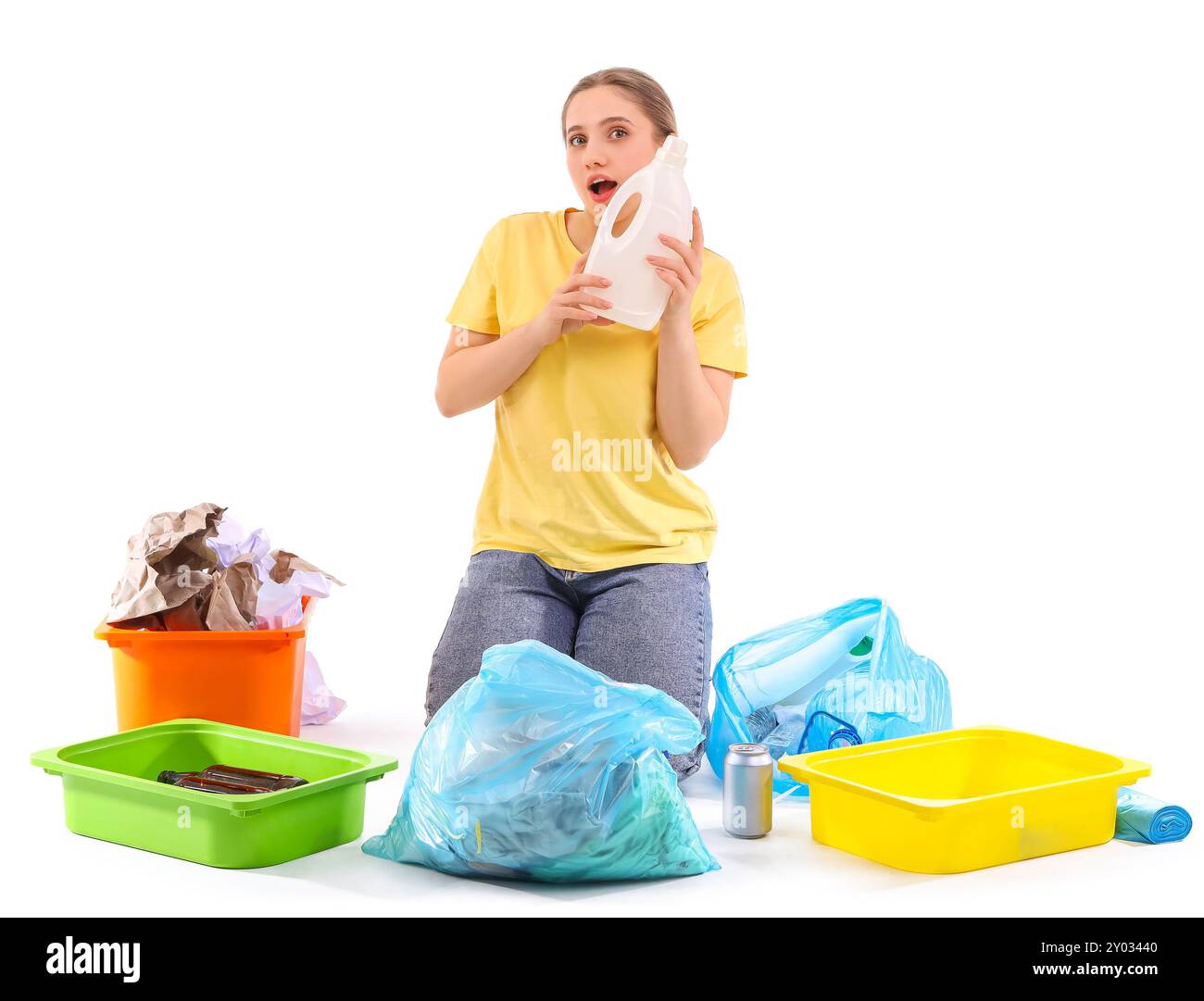 Shocked young woman sorting trash on white background Stock Photo - Alamy