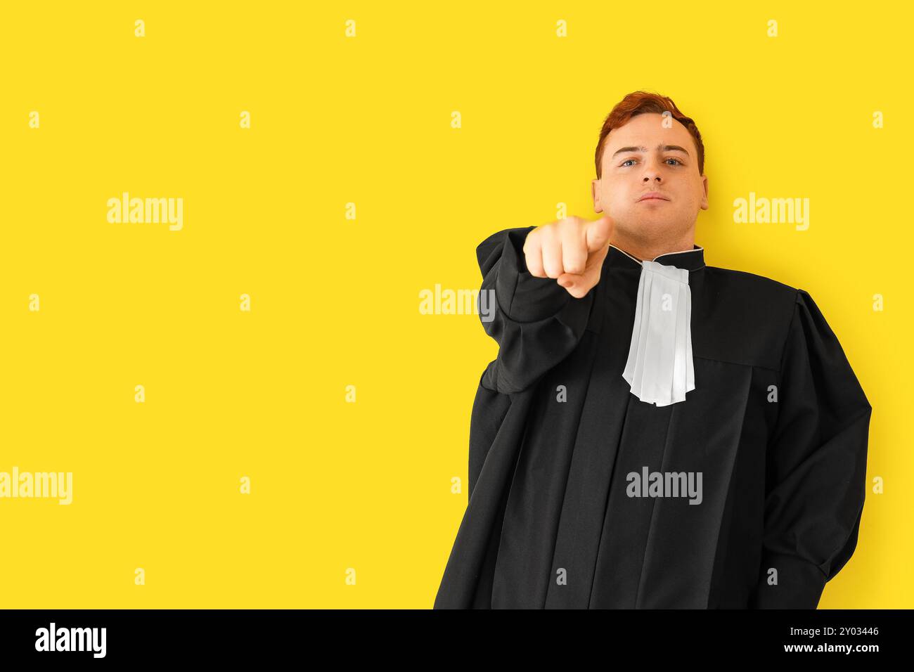 Male judge pointing at viewer on yellow background, top view Stock ...