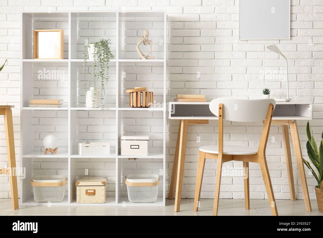 Interior of living room with shelving unit, table and chair Stock Photo ...