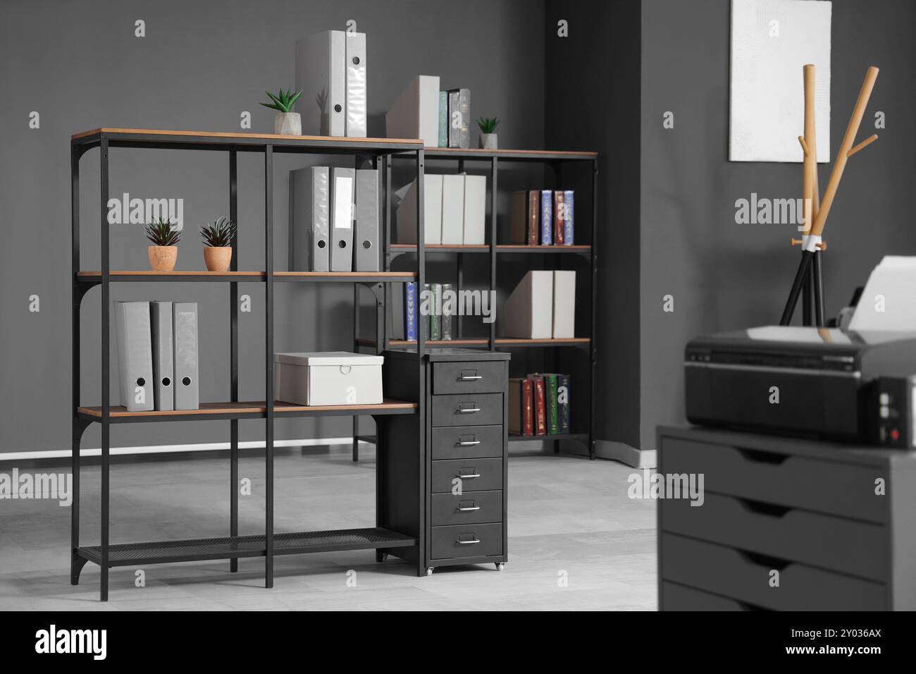 Interior of office with shelving units, chest of drawers and printer ...