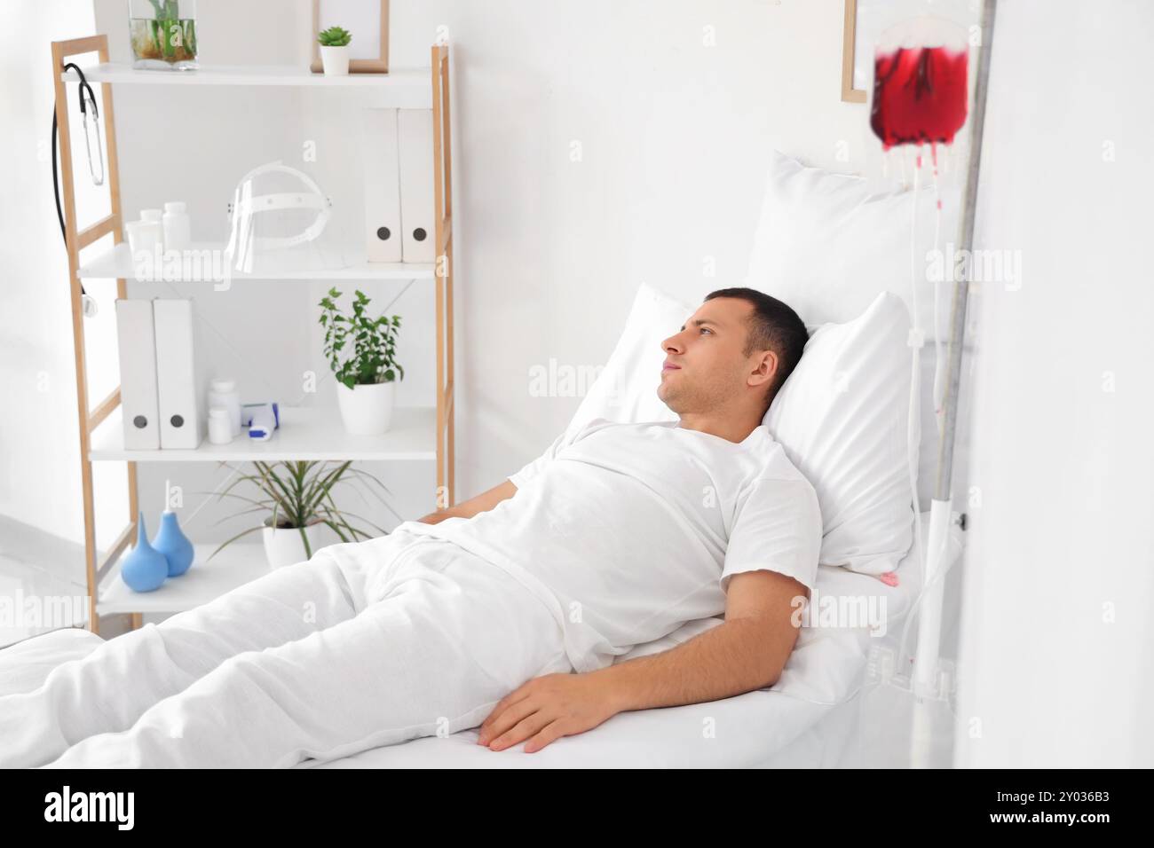 Male patient transfusing blood on bed in hospital ward Stock Photo - Alamy
