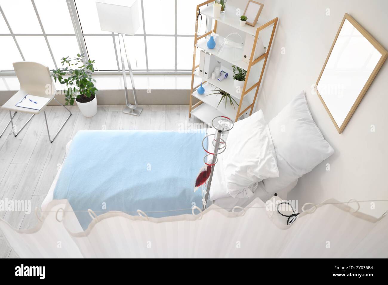Interior of hospital ward with bed, drip stand and shelf unit Stock ...