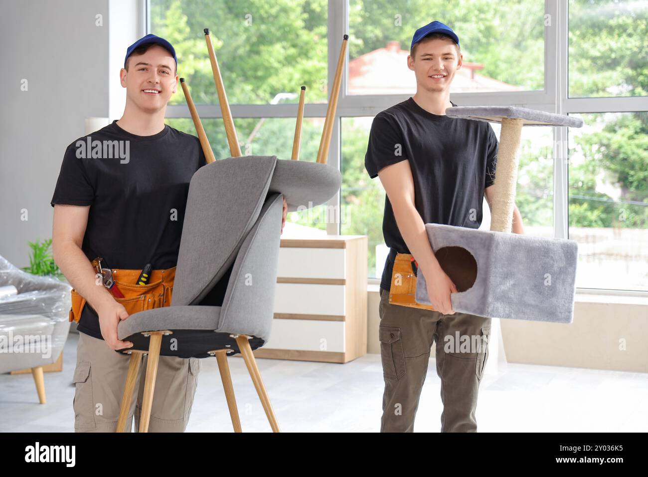 Men carrying chairs hi-res stock photography and images - Alamy