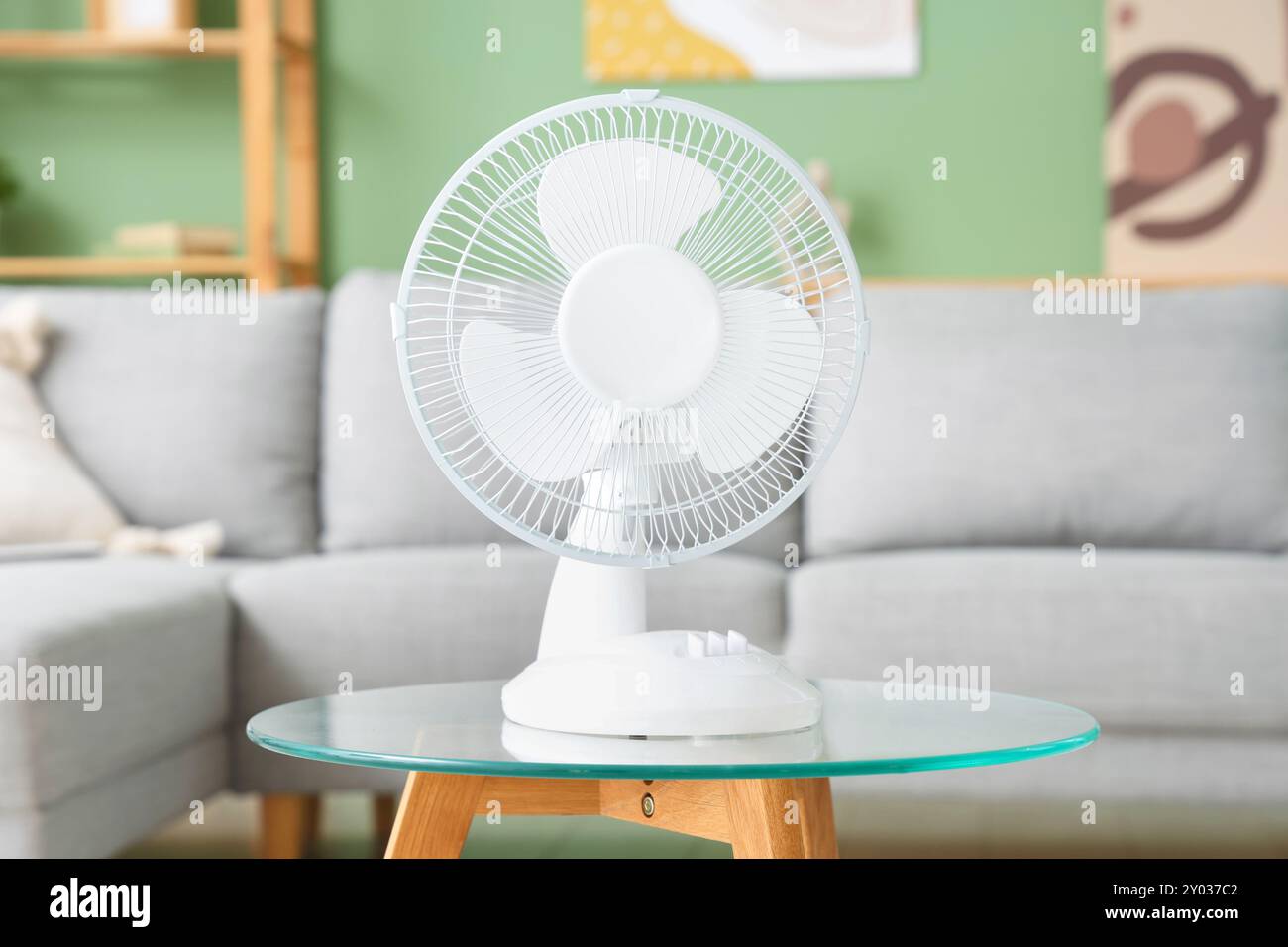 Glass table with modern electric fan in interior of living room Stock ...