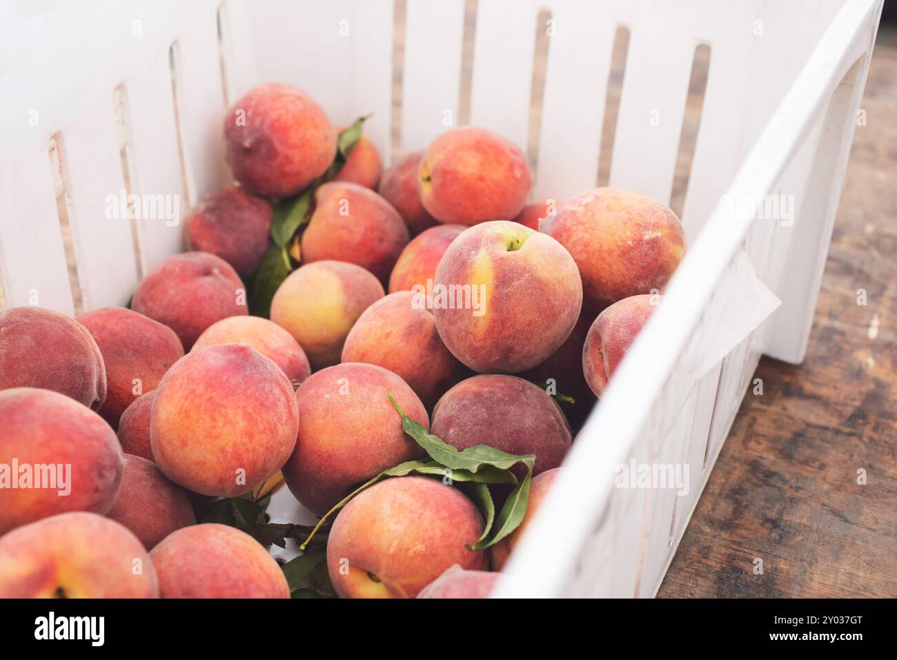 A view of a stack of peach crate, on display at a local farmers market ...