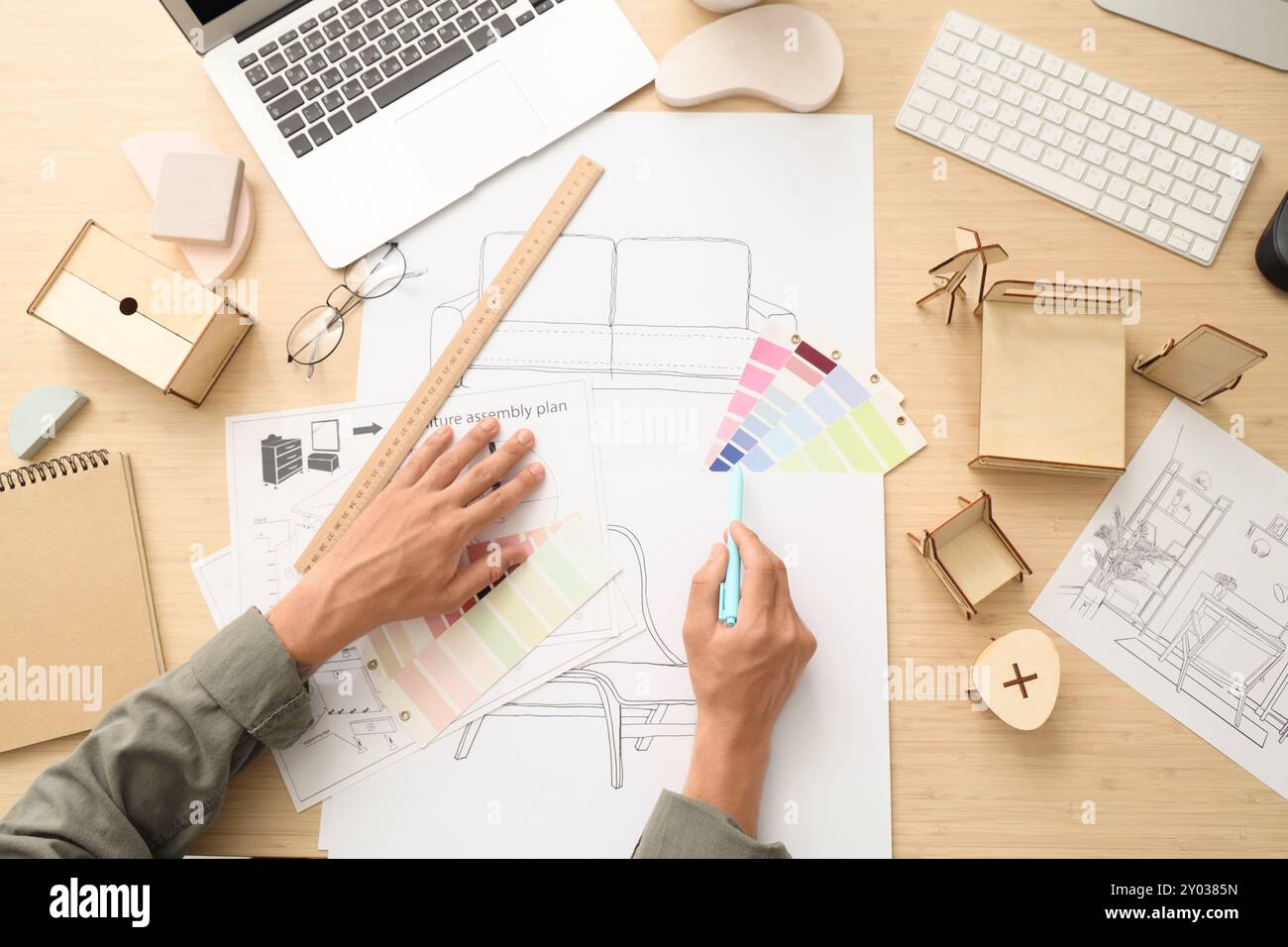 Male furniture designer with color palettes working on table, top view ...