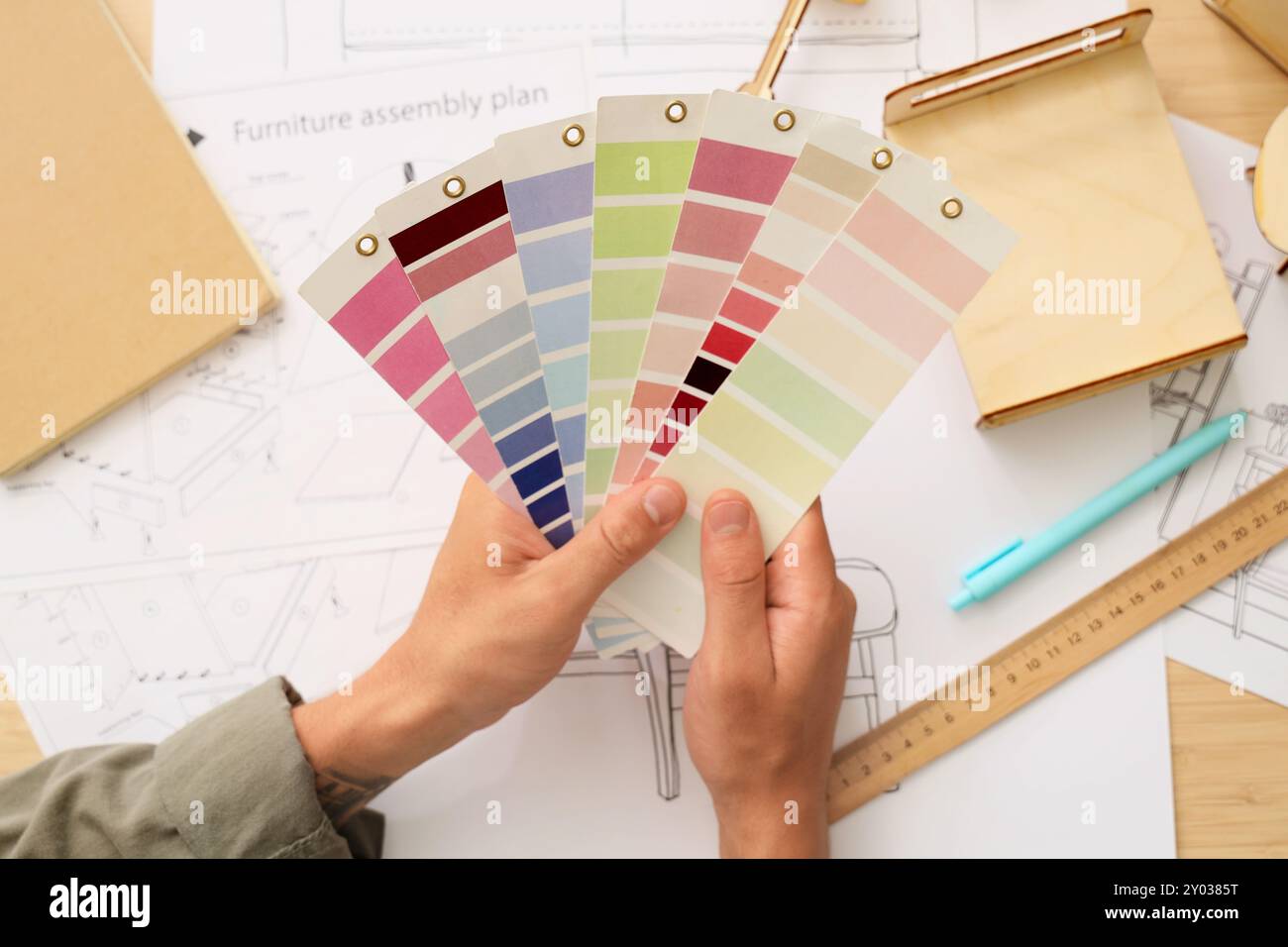 Male furniture designer with color palettes on table, top view Stock ...
