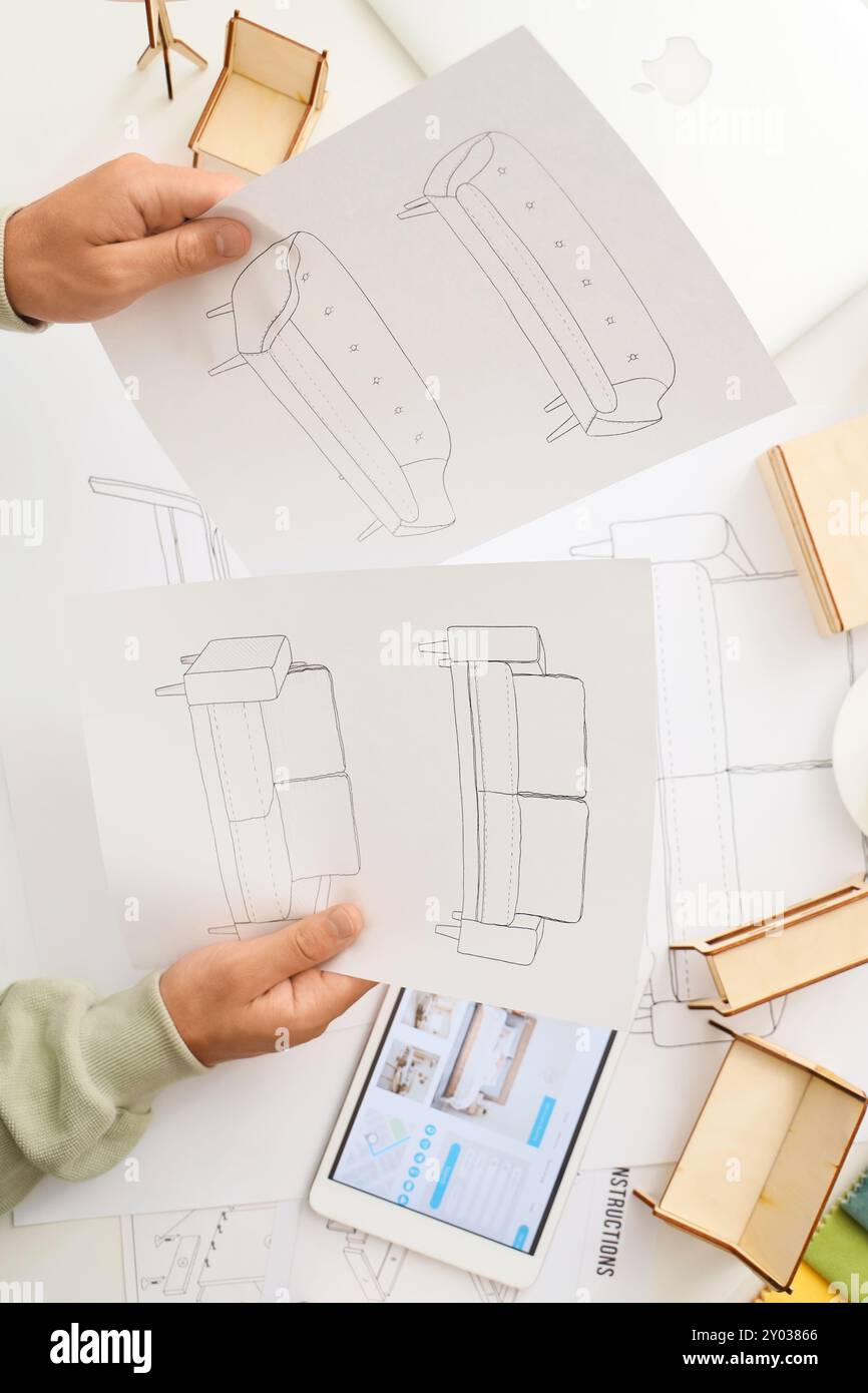 Male furniture designer with drawings on white table, top view Stock ...