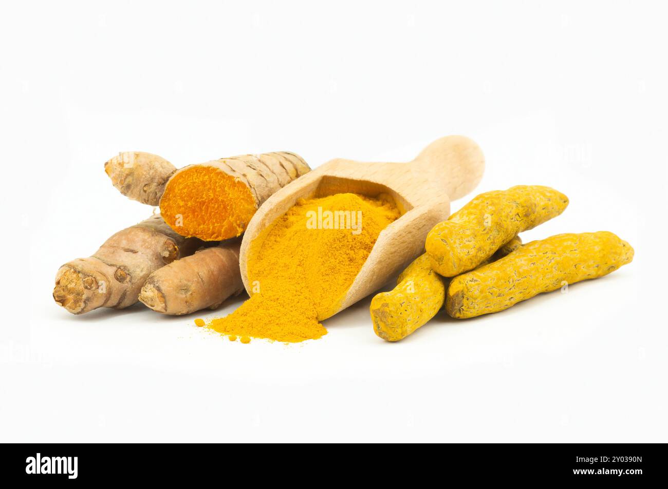 Turmeric powder in spoon and turmeric root isolated on white background ...