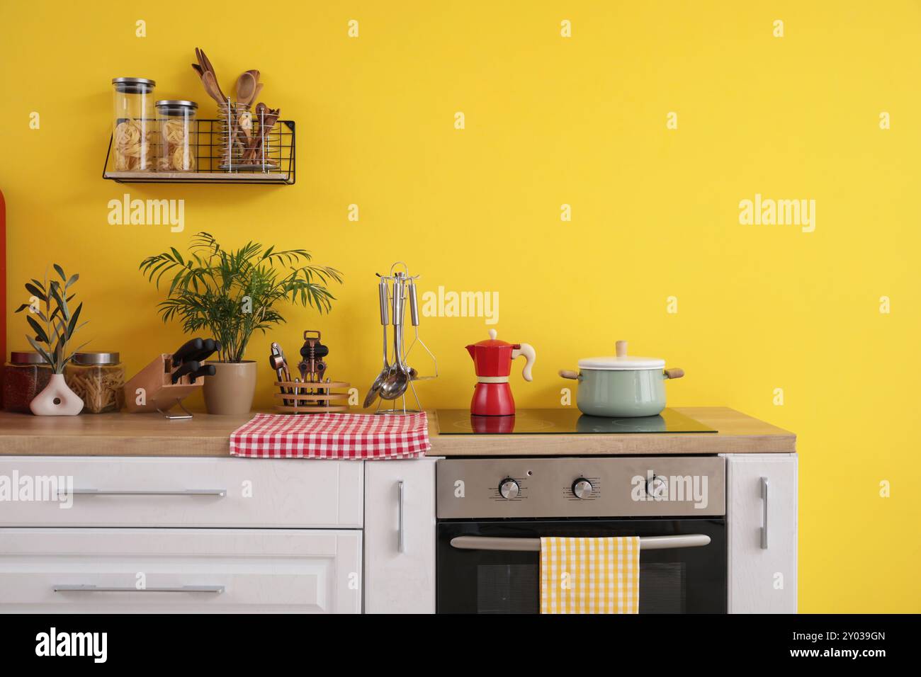 Interior of kitchen with counter, oven and utensils Stock Photo - Alamy