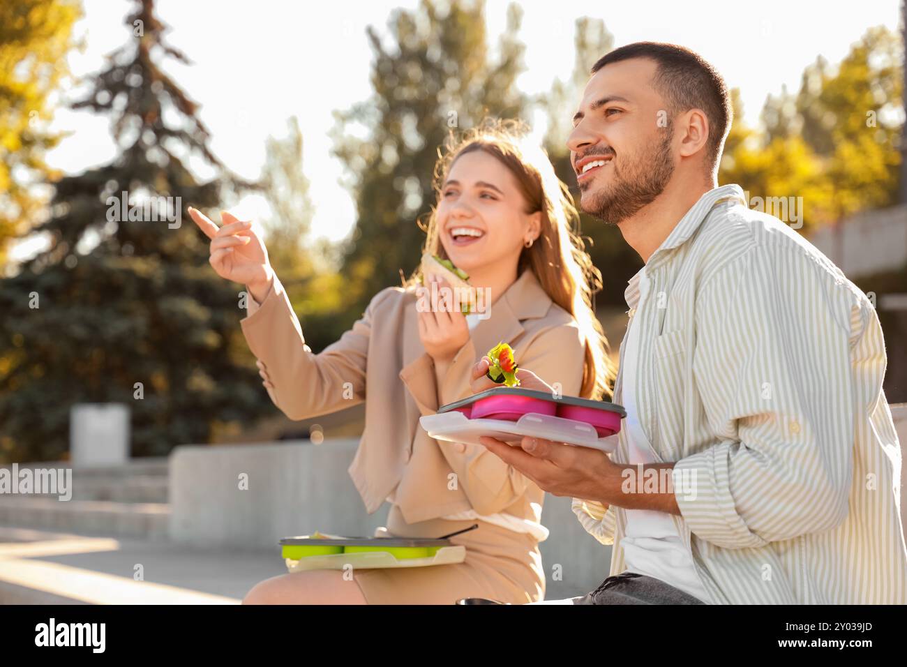 Young colleagues having lunch outdoors Stock Photo - Alamy