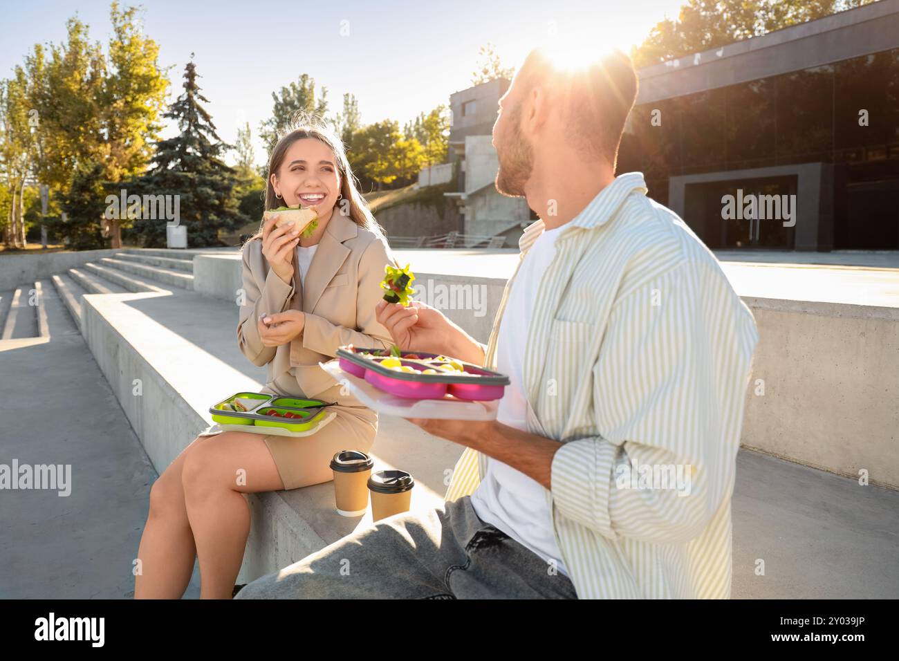 Young colleagues having lunch outdoors Stock Photo - Alamy