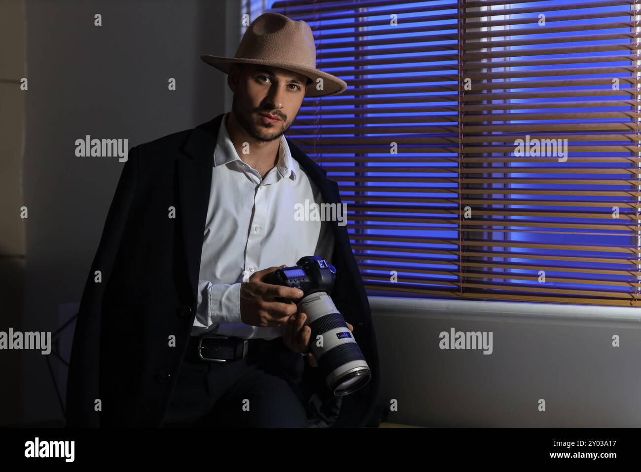 Male detective with photo camera near window in room at night Stock ...