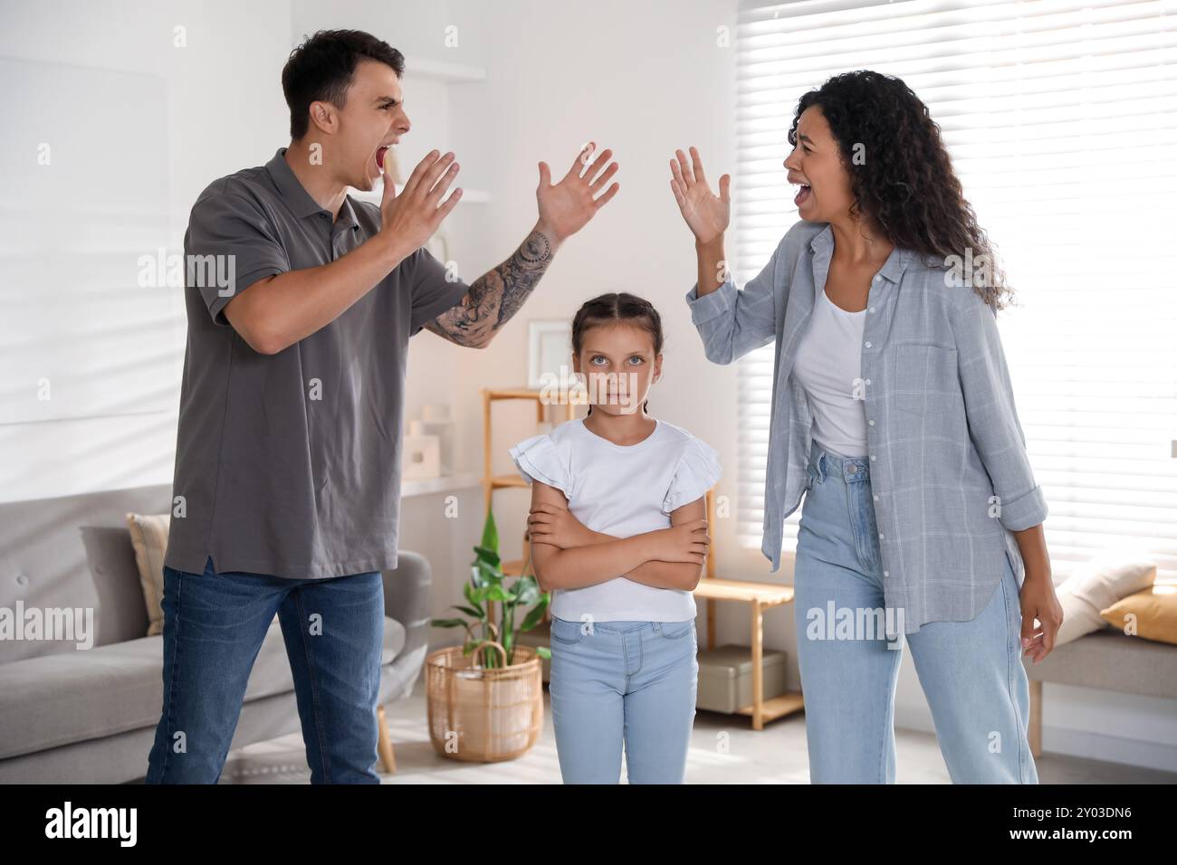 Divorce concept. Angry couple arguing and their sad daughter at home ...