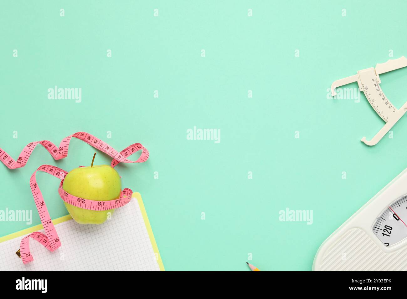 Flat lay composition with body fat caliper and measuring tape on ...