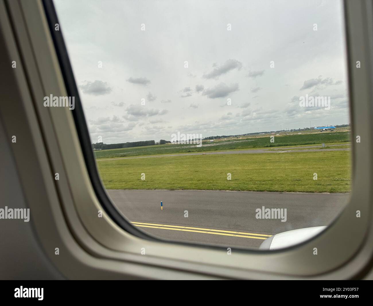 View on runway and surroundings through plane window Stock Photo - Alamy