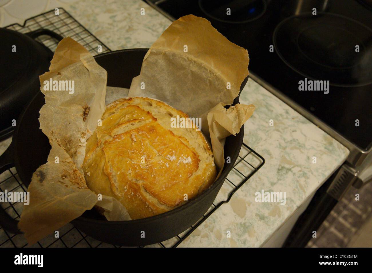Overhead view of a Black Dutch golden crust bread with parchment paper ...