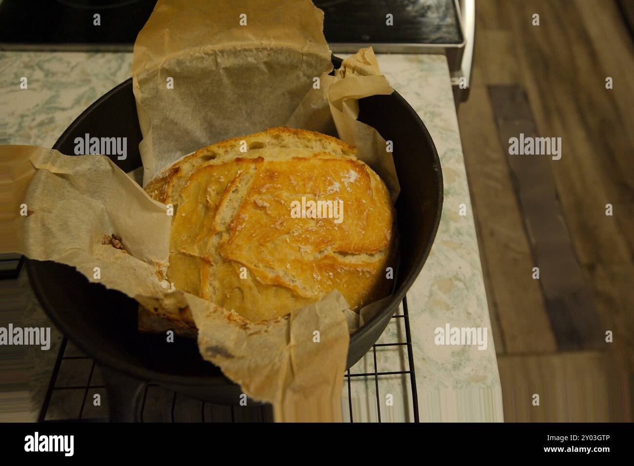 Overhead view of a Black Dutch golden crust bread with parchment paper ...