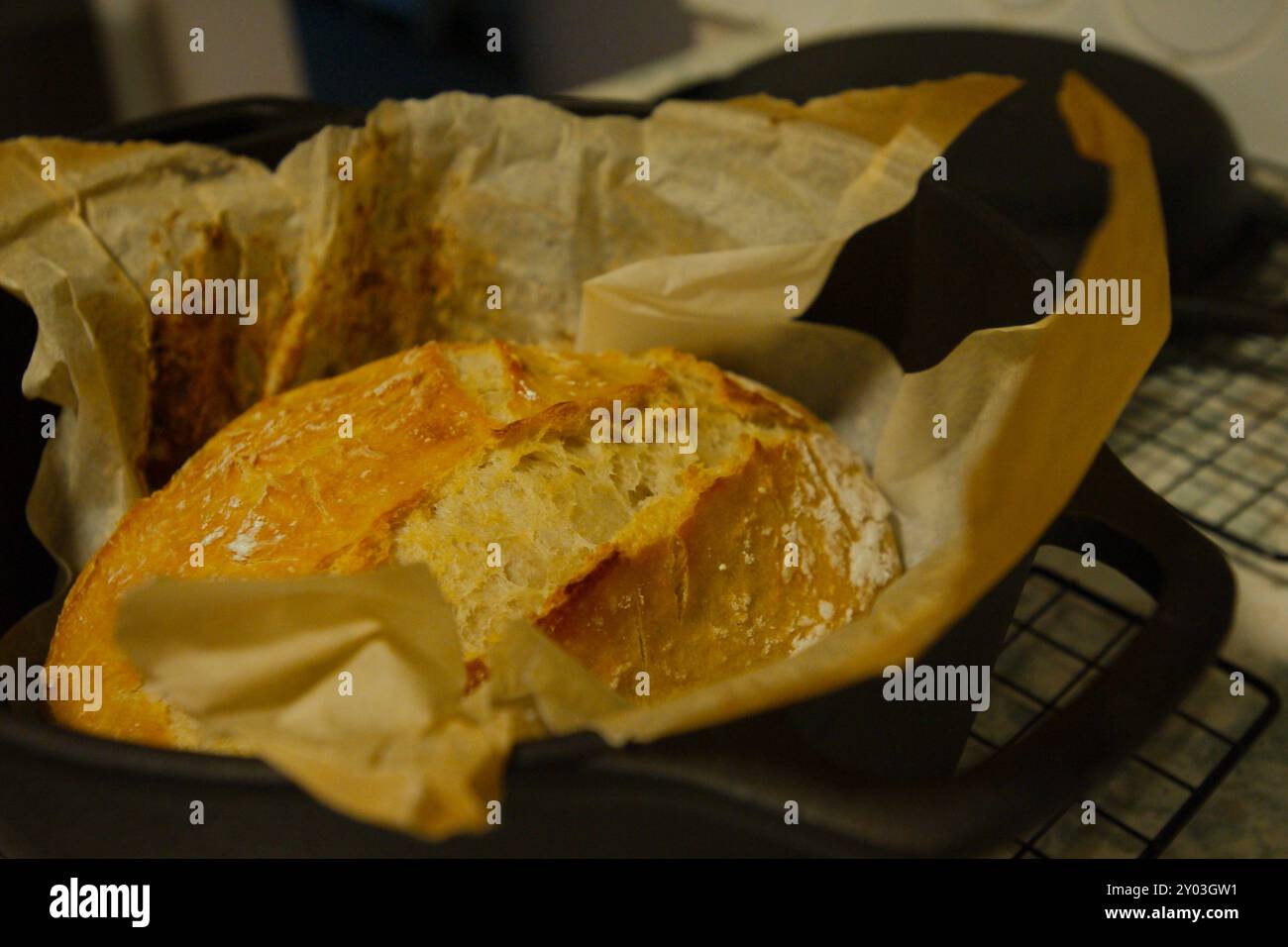 Overhead view of a Black Dutch golden crust bread with parchment paper ...