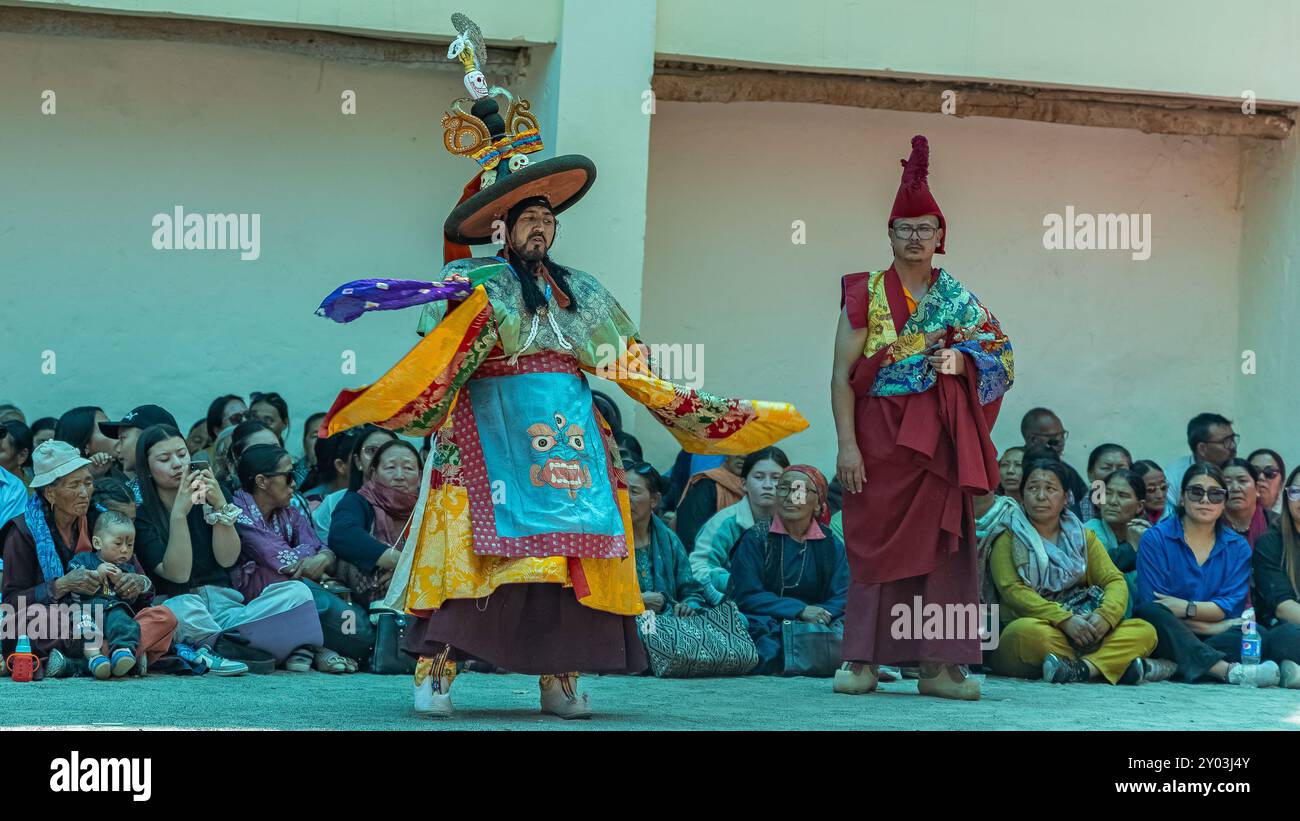 Ladakhi monk performing dance in an event wearing traditional costume ...