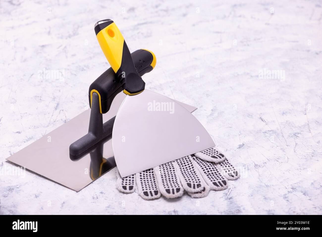 A set of hand tools for plastering and leveling the walls on white-grey ...