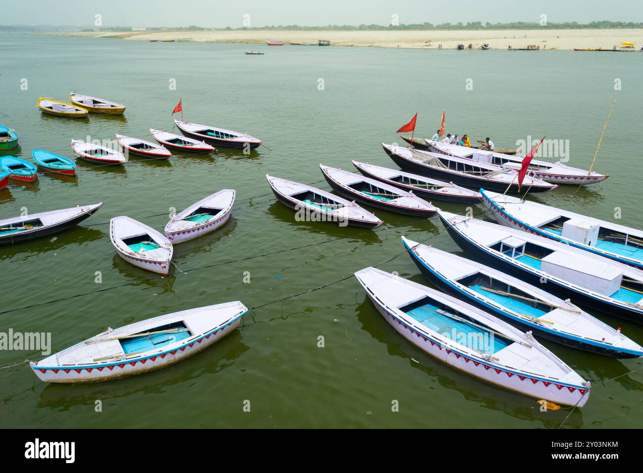 93) Unattended boats float on the Ganges river in the pre-monsoon heat ...