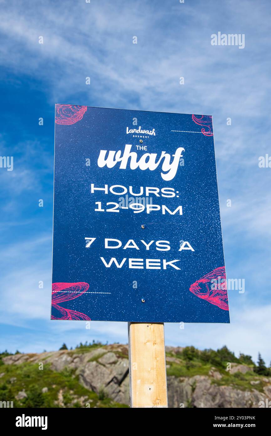 The wharf hours sign at Quidi Vidi fishing village in St. John's ...