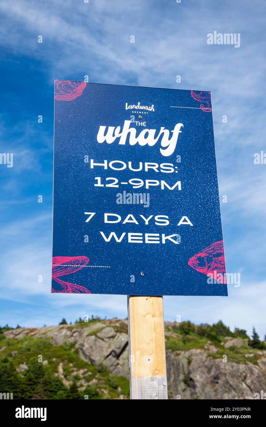 The wharf hours sign at Quidi Vidi fishing village in St. John's ...