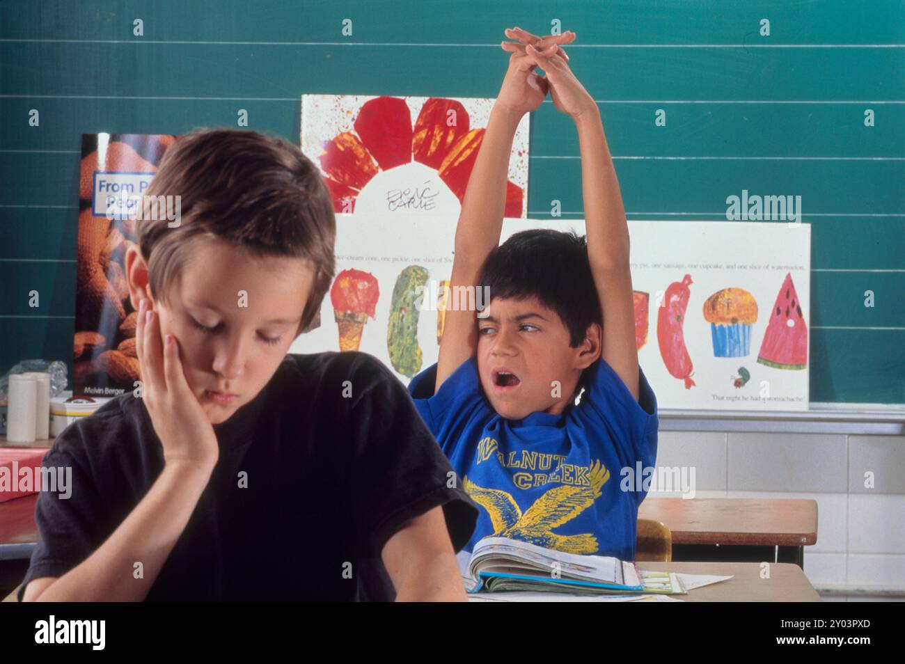 Austin Texas USA, 1995: Hispanic boy stretches and yawns in classroom ...