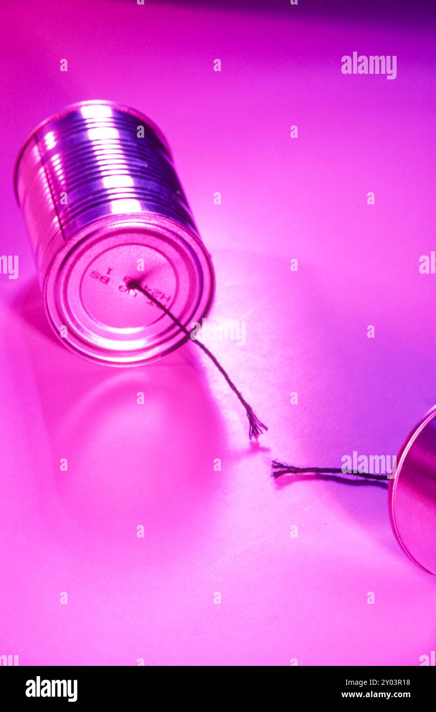 concept photo of broken communication showing two tin cans and a broken ...