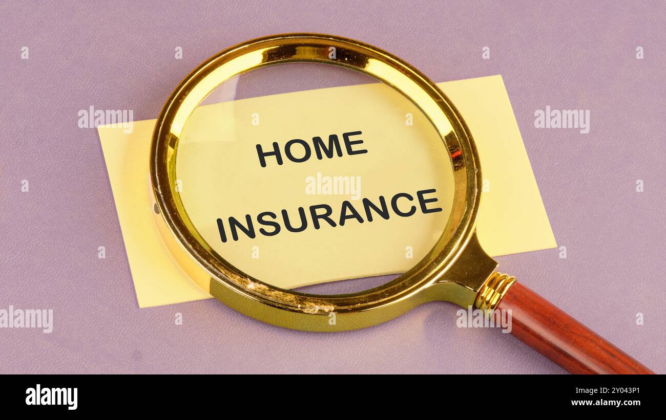 HOME INSURANCE words written through a magnifying glass on yellow paper ...