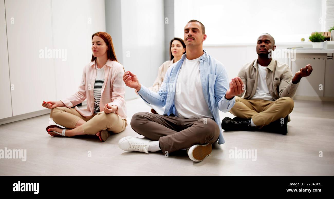 Employees meditating in yoga hi-res stock photography and images - Alamy
