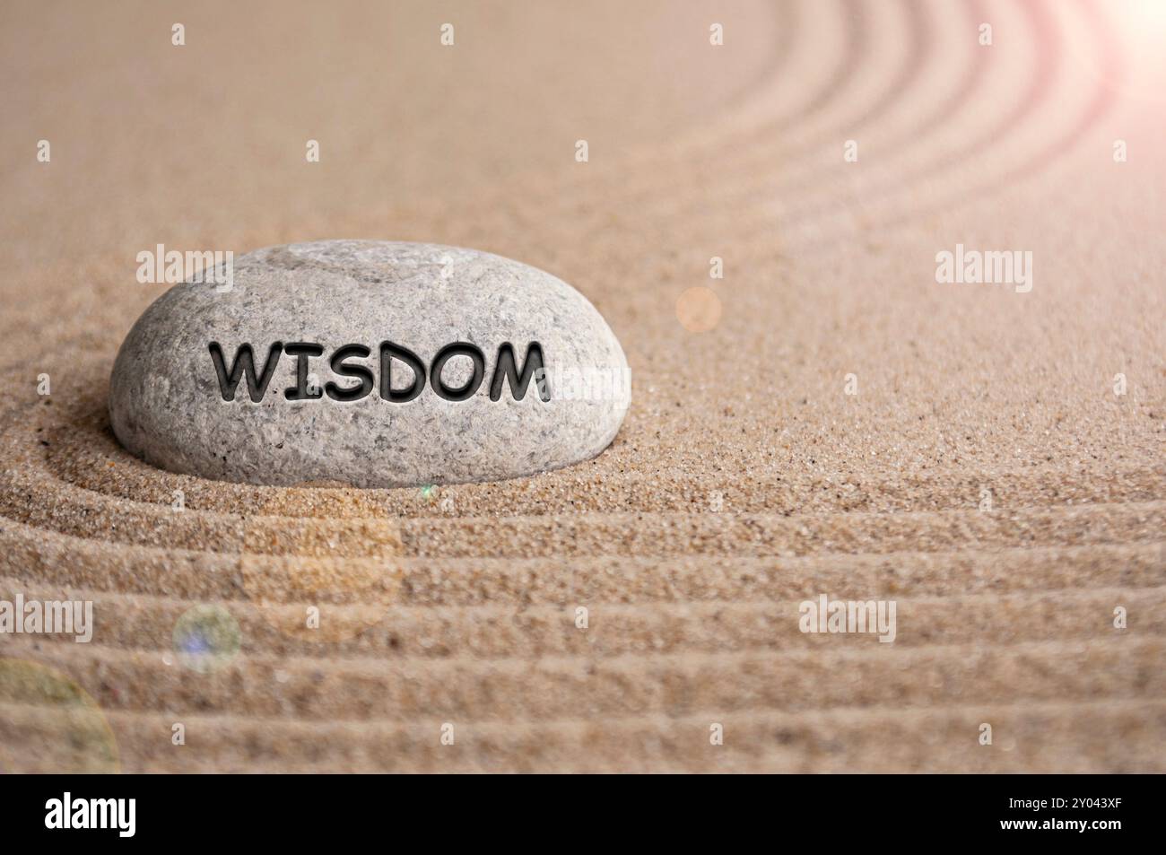 Wisdom text engraved on stone with sand beach background. Peace of mind ...
