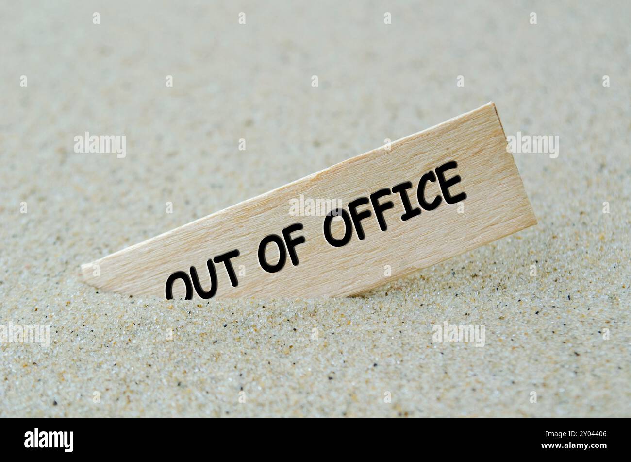 Out Of Office text on wooden stick with beach sand background. Off work ...