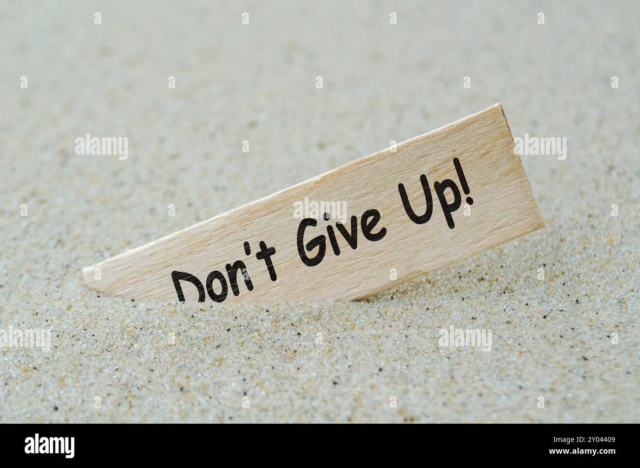 Do not give up text on wooden stick with beach sand background ...