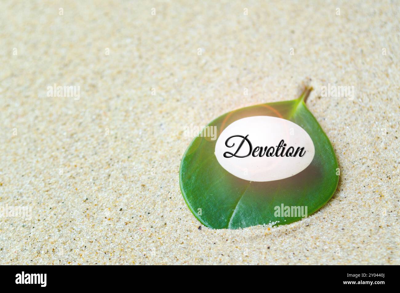 Devotion text on shining zen stock with beach sand background ...