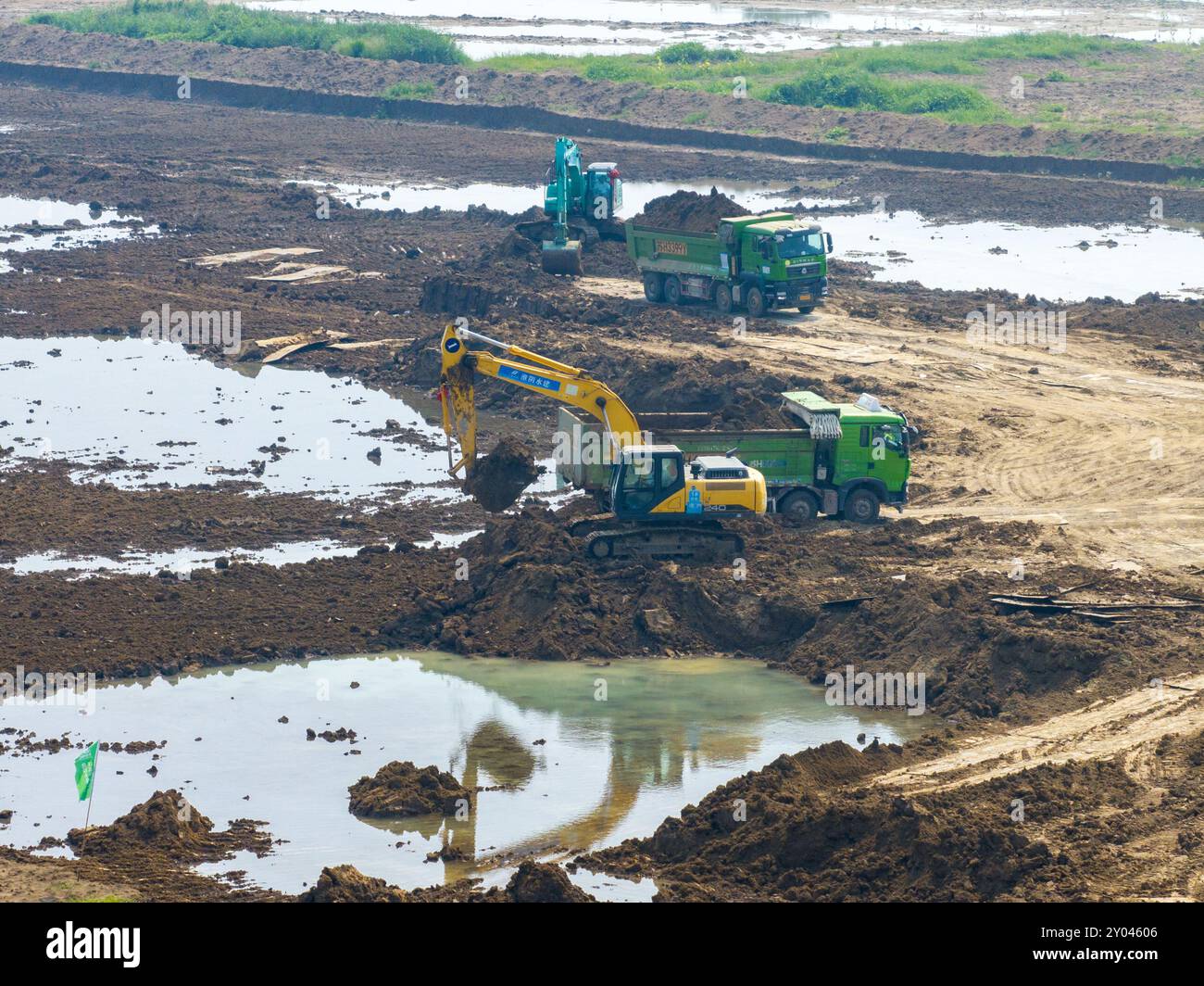HUAI'AN, CHINA - SEPTEMBER 1, 2024 - Excavators and trucks work in the ...